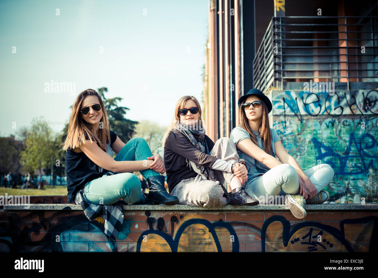 three beautiful friends authentic in urban contest Stock Photo - Alamy