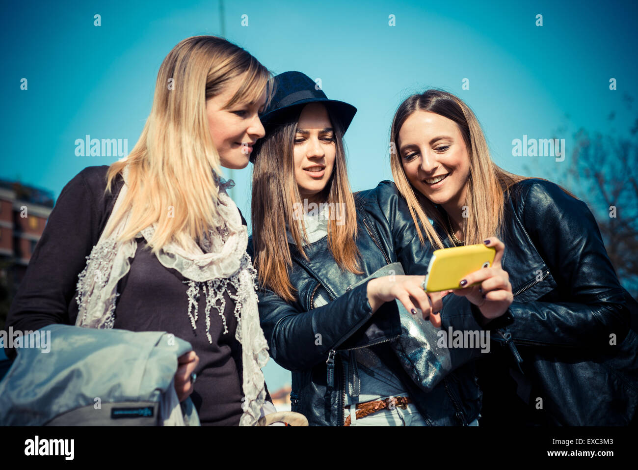 three beautiful friends authentic in urban contest Stock Photo - Alamy