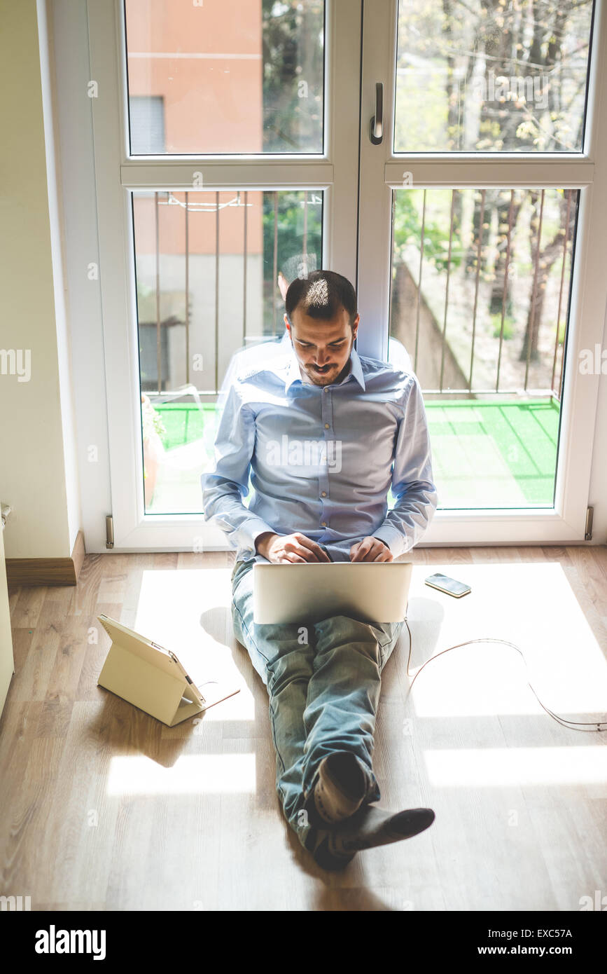 elegant business multitasking multimedia man using devices at home ...