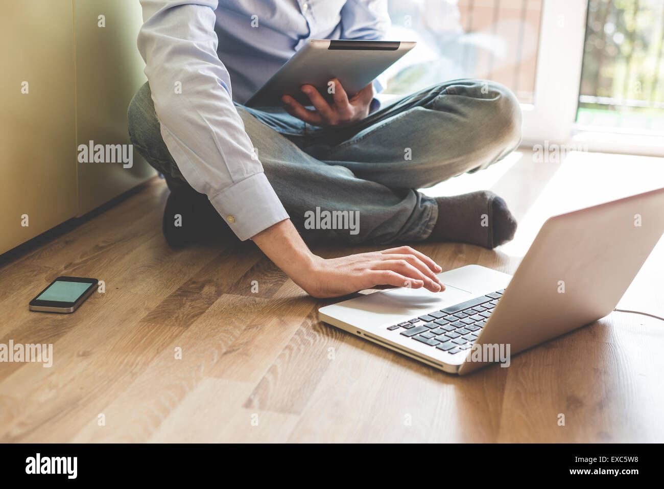 elegant business multitasking multimedia man using devices at home ...