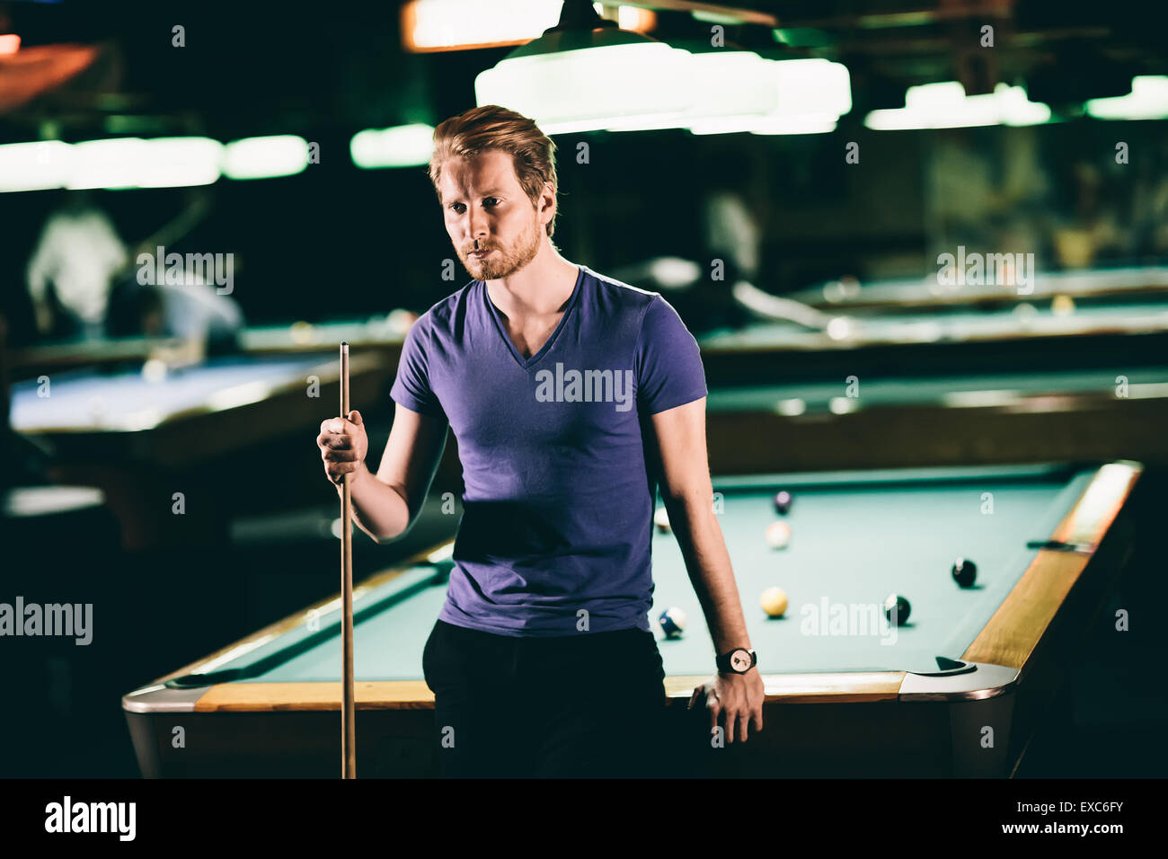 Young man playing pool Stock Photo - Alamy