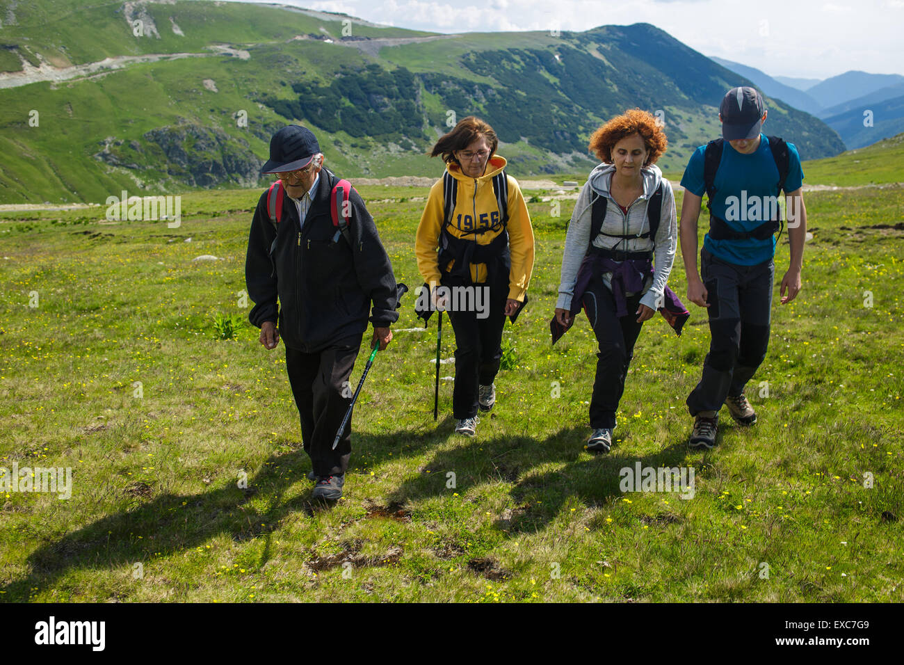 Family of hikers walking together on high mountains Stock Photo - Alamy