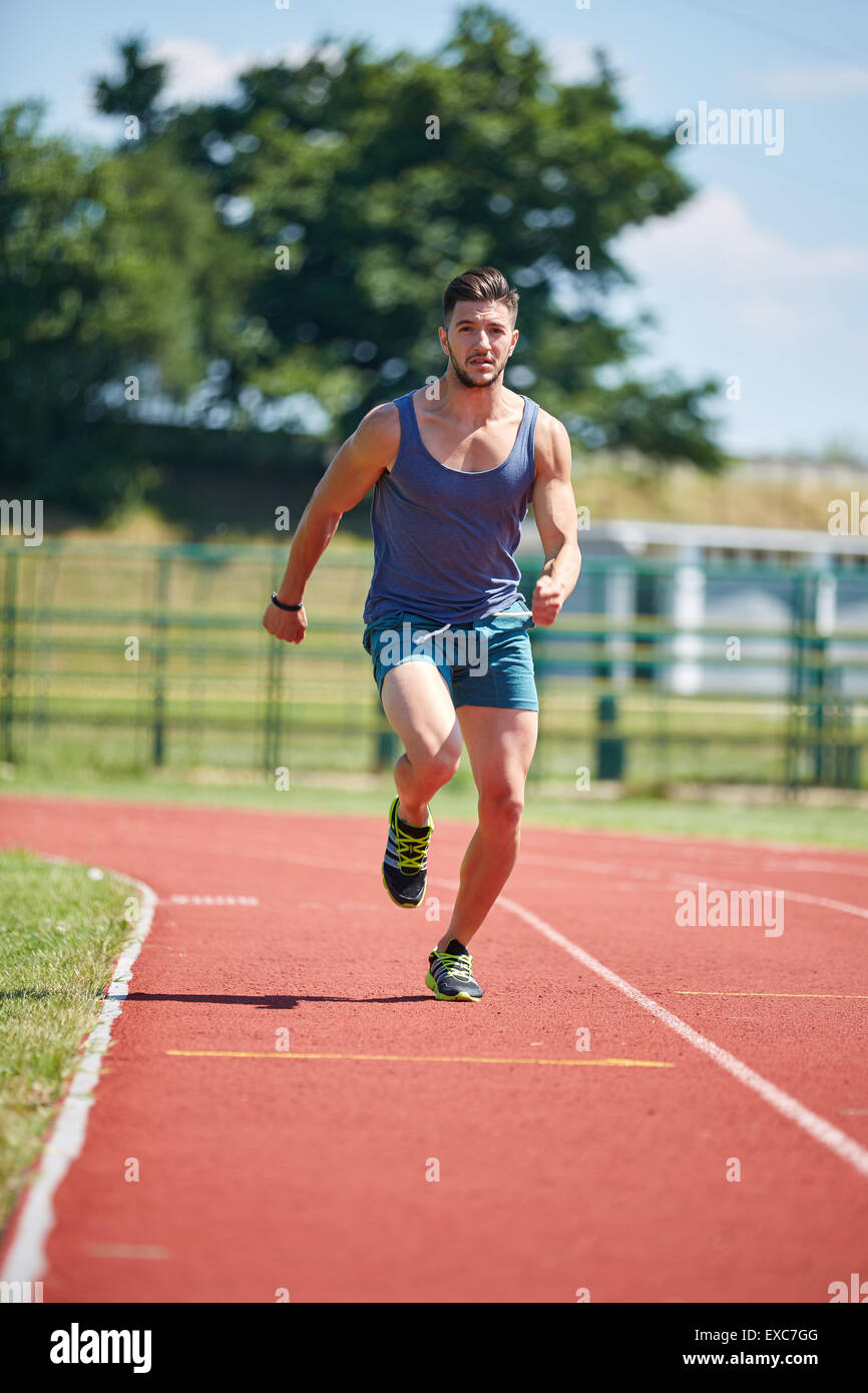 Young athlete runner, sprinting on the stadium track Stock Photo - Alamy