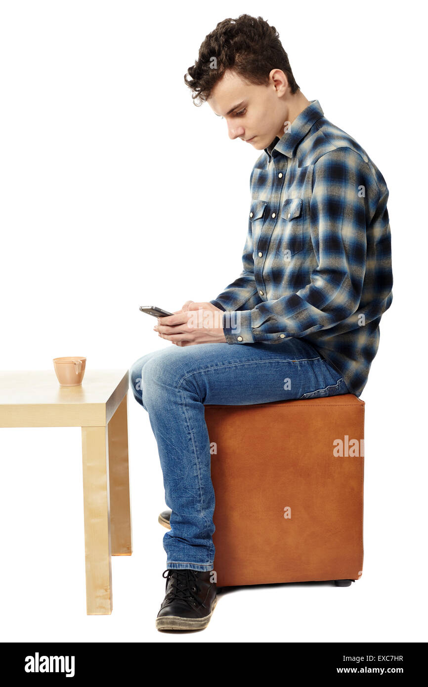 Teenage boy texting using a smartphone isolated on white Stock Photo ...