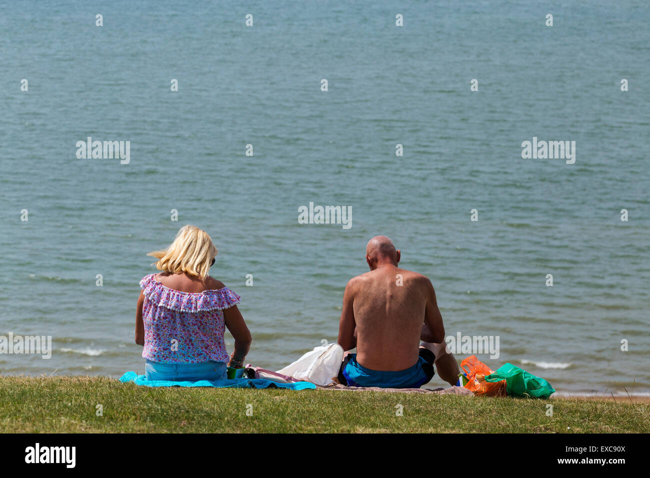 A Couple of People Sunbathing Stock Photo - Alamy