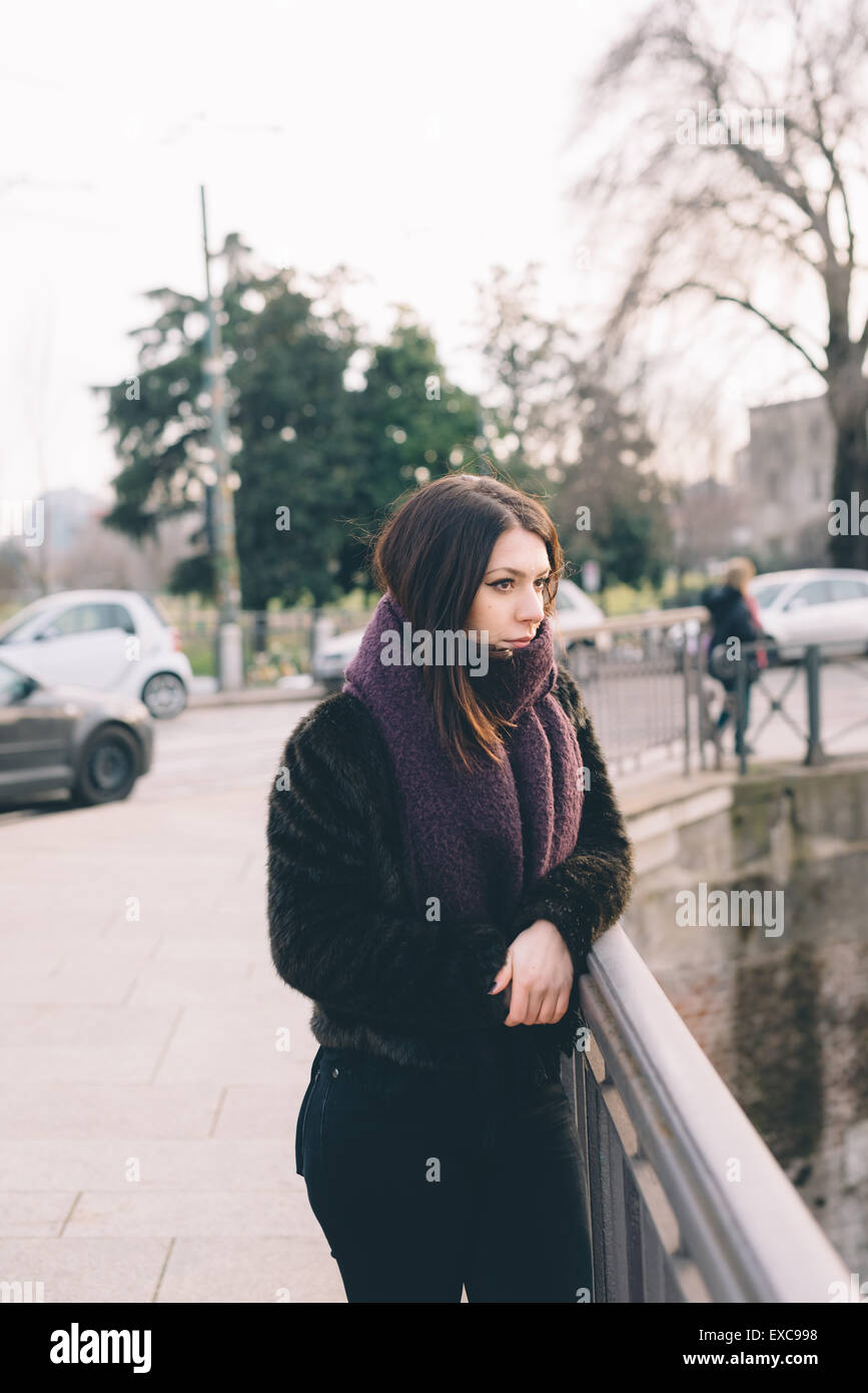 Young beautiful brunette caucasian girl lean on an handrail Stock Photo ...