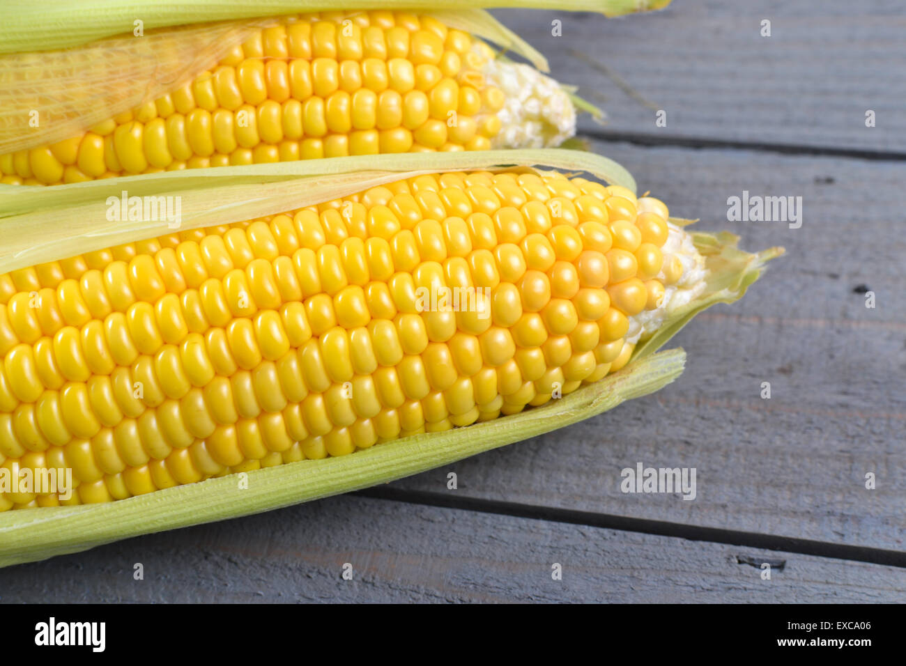 The Golden Corn at wooden background Stock Photo - Alamy