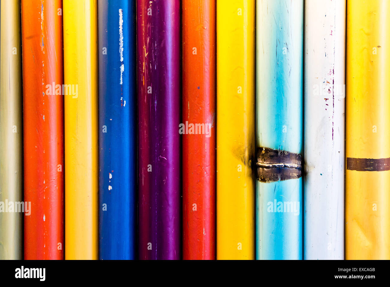 Colorful metal poles as a background image Stock Photo - Alamy