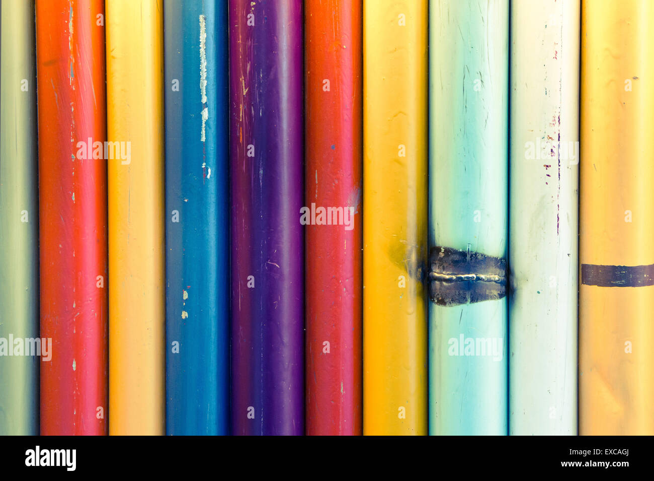 Colorful metal poles as a background image Stock Photo - Alamy