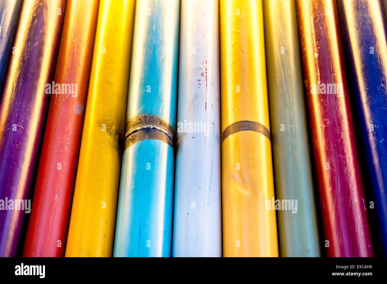 Colorful metal poles as a background image Stock Photo - Alamy