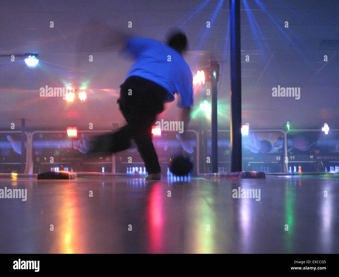 Bowlers at night glow bowling at a bowling alley Stock Photo - Alamy