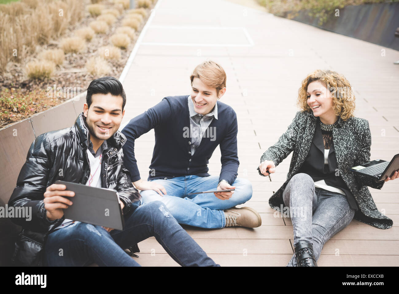 Multiracial business people working outdoor in town connected with ...