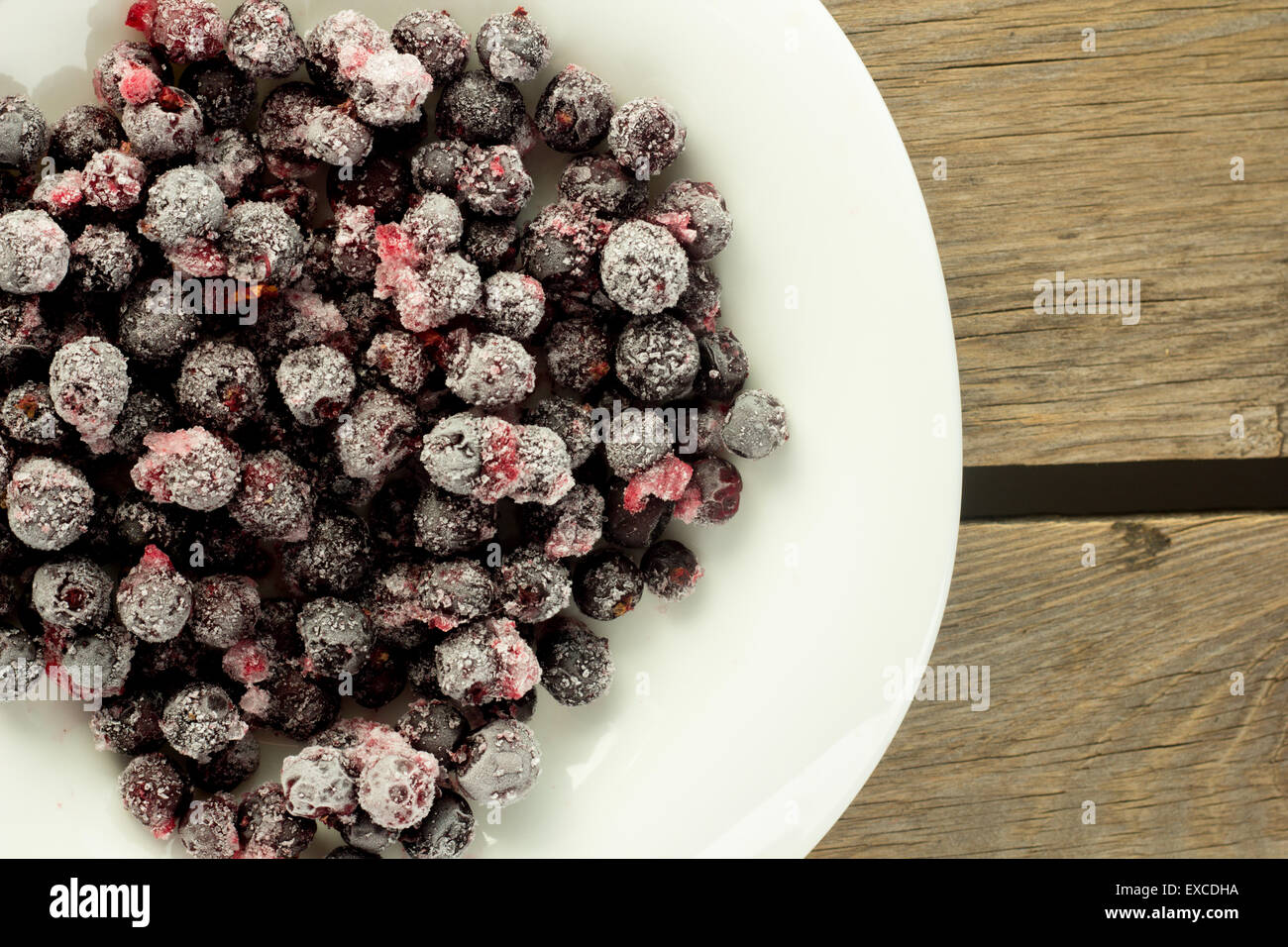 Frozen black currant on white dish top view selective focus Stock Photo ...