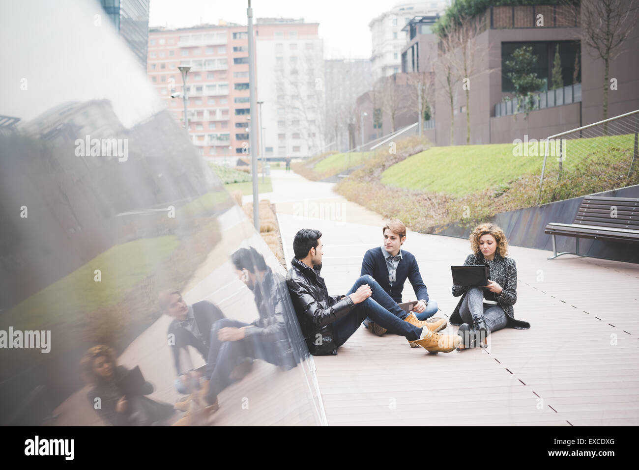 Multiracial business people working outdoor in town connected with ...