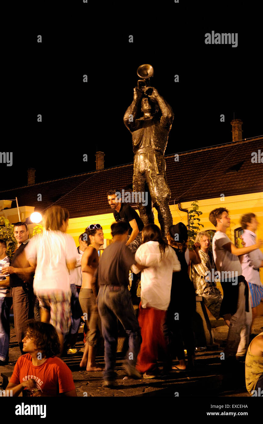 People dancing around the Guča trumpeter statue during the 50th edition ...