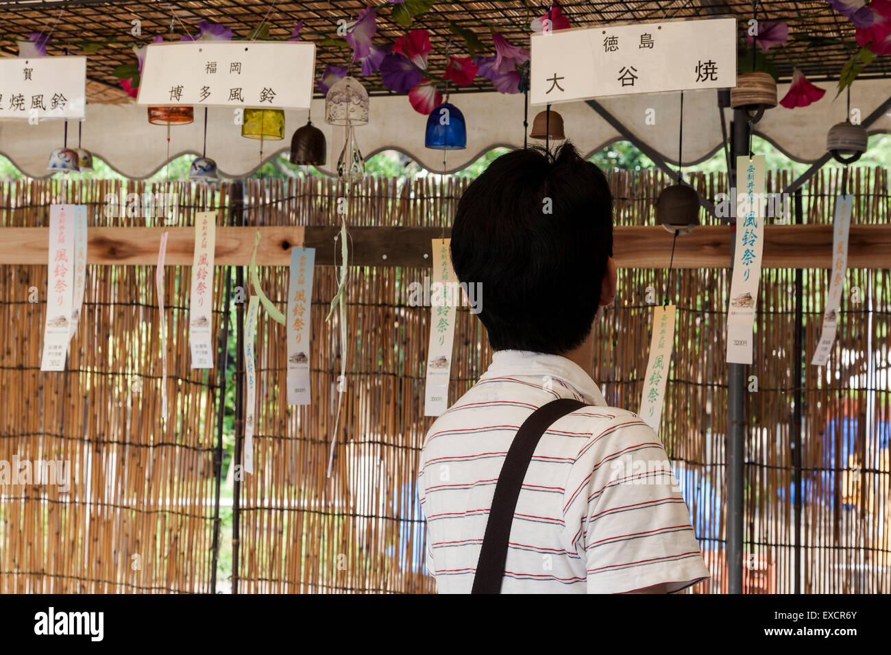 A visitors looks at Japanese wind chimes (Fuurin) made of glass during ...
