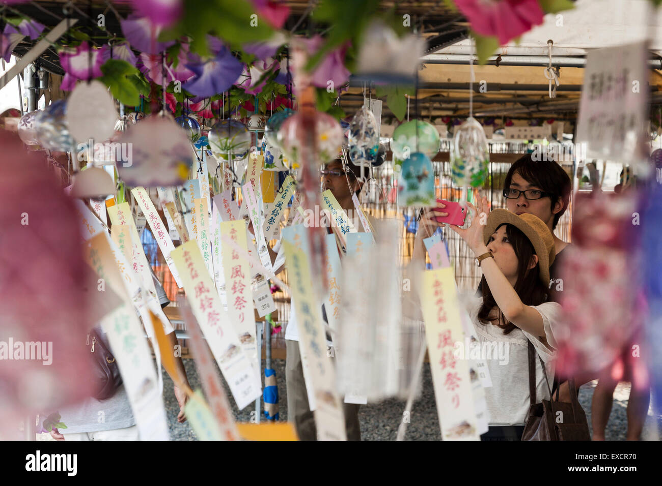 Visitors look at Japanese wind chimes (Fuurin) made of glass during the ...