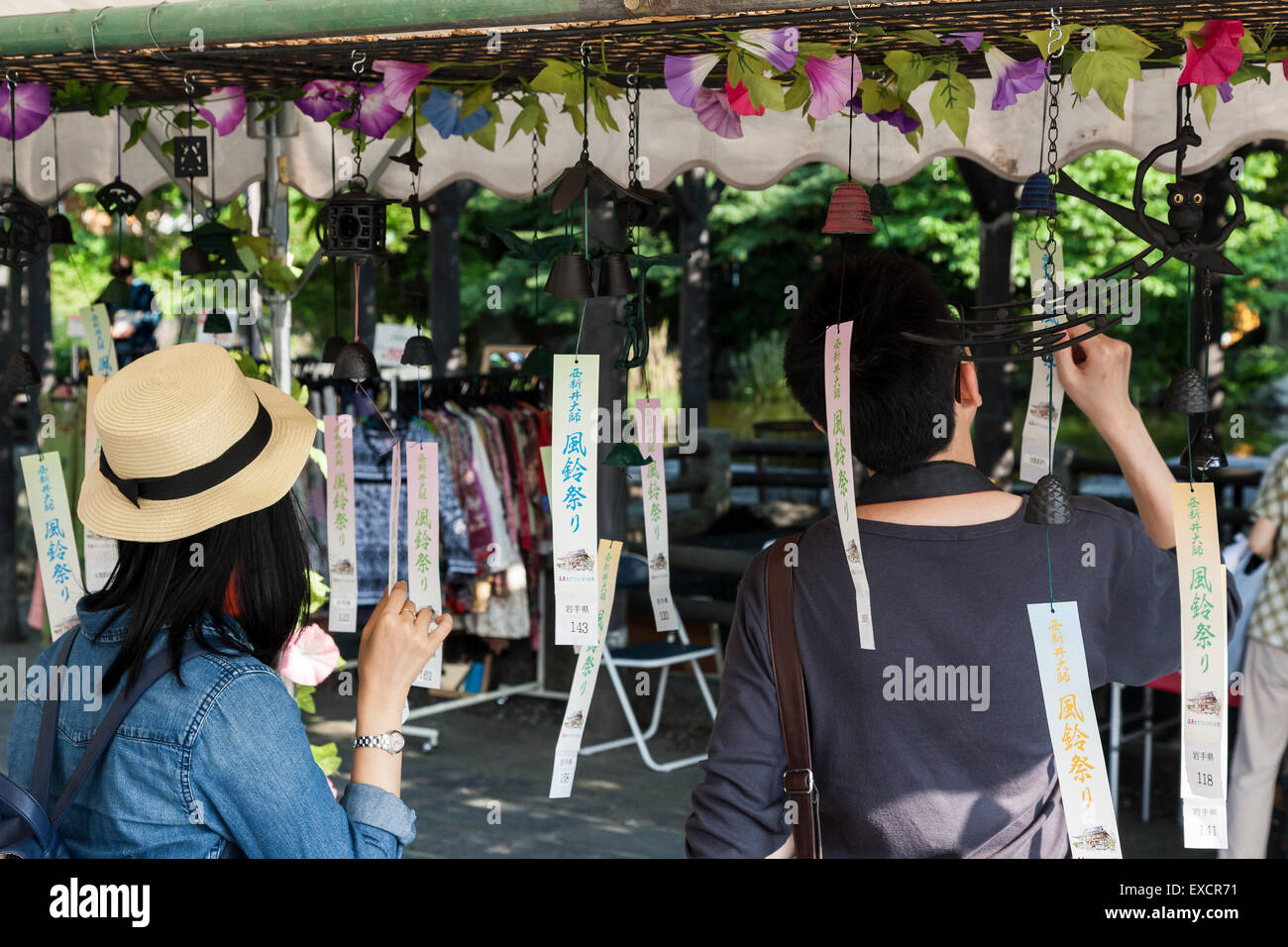 Visitors look at Japanese wind chimes (Fuurin) made of glass during the ...