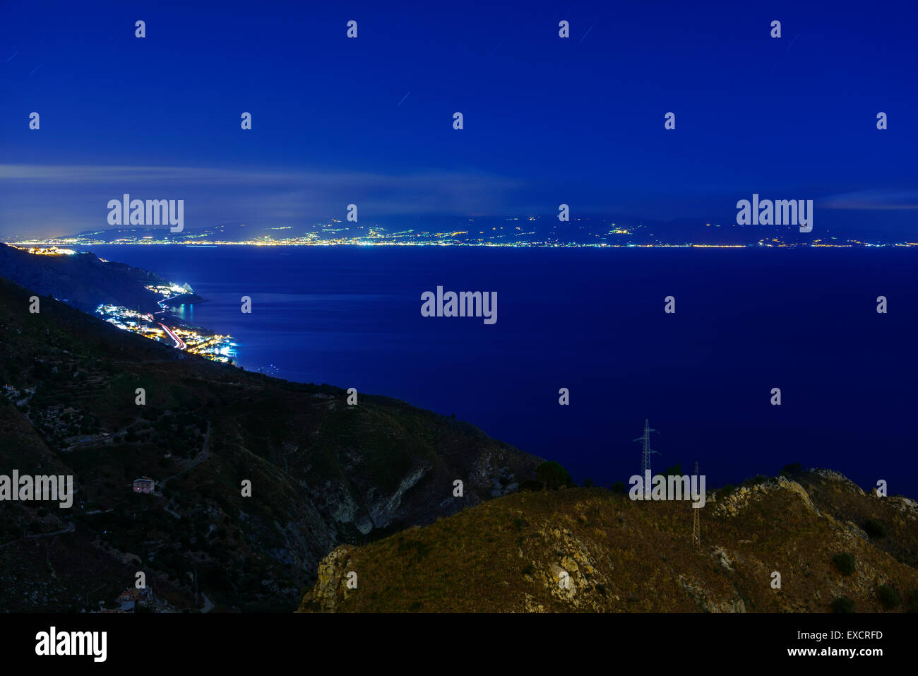 View to the Italian mainland from Sicily at night Stock Photo - Alamy