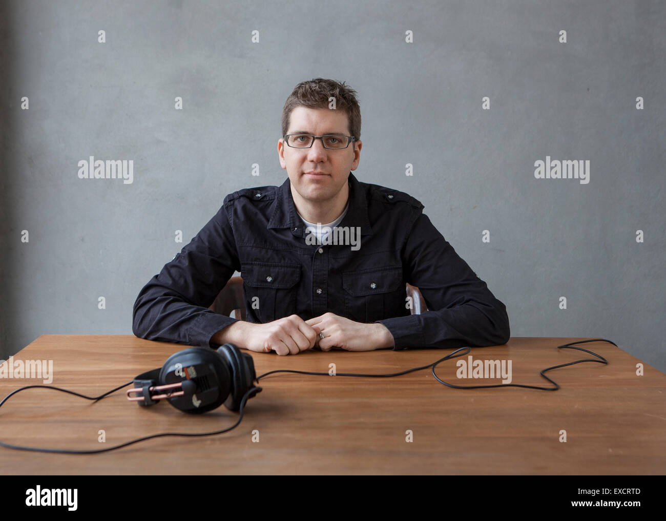 a studio portrait of a stylish hipster DJ wearing his headphones Stock ...