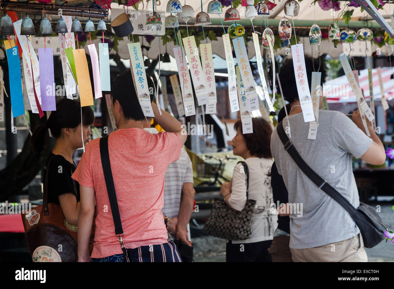 Visitors look at Japanese wind chimes (Fuurin) made of glass during the ...