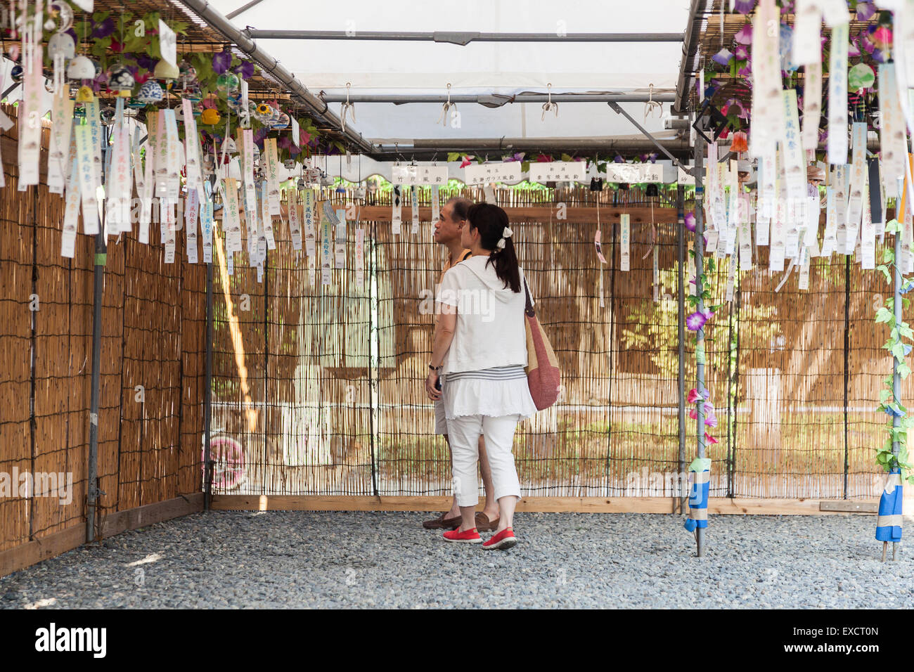 Visitors look at Japanese wind chimes (Fuurin) made of glass during the ...