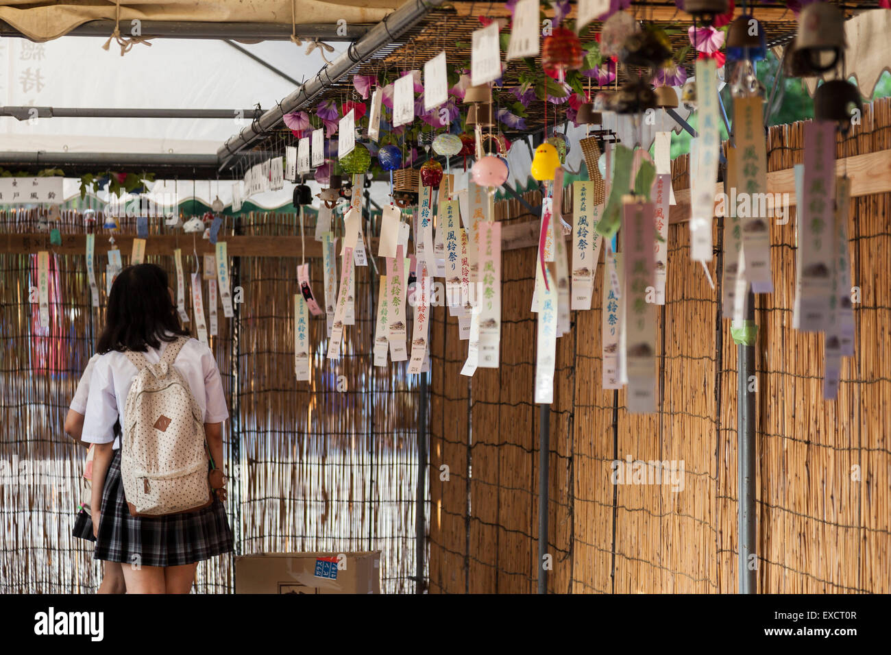 Visitors look at Japanese wind chimes (Fuurin) made of glass during the ...