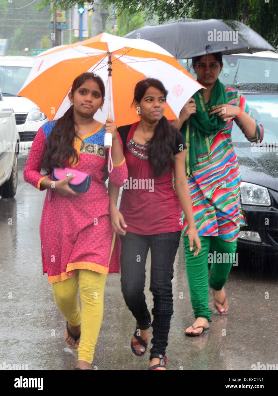 Allahabad, India. 11th July, 2015. Girls use umbrella during rain. The ...