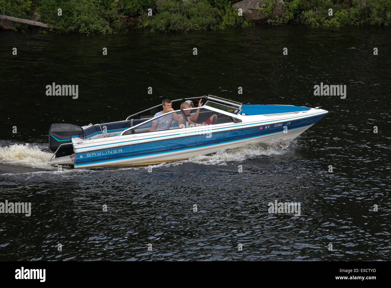 Three teenage boys in a Bayliner speed boat. USA US America Long Lake ...