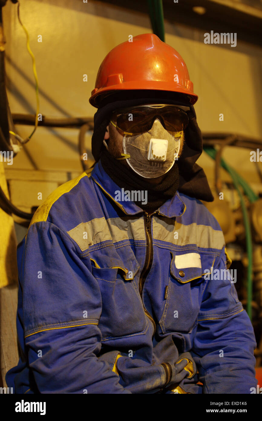 The worker in overalls and a respirator Stock Photo - Alamy