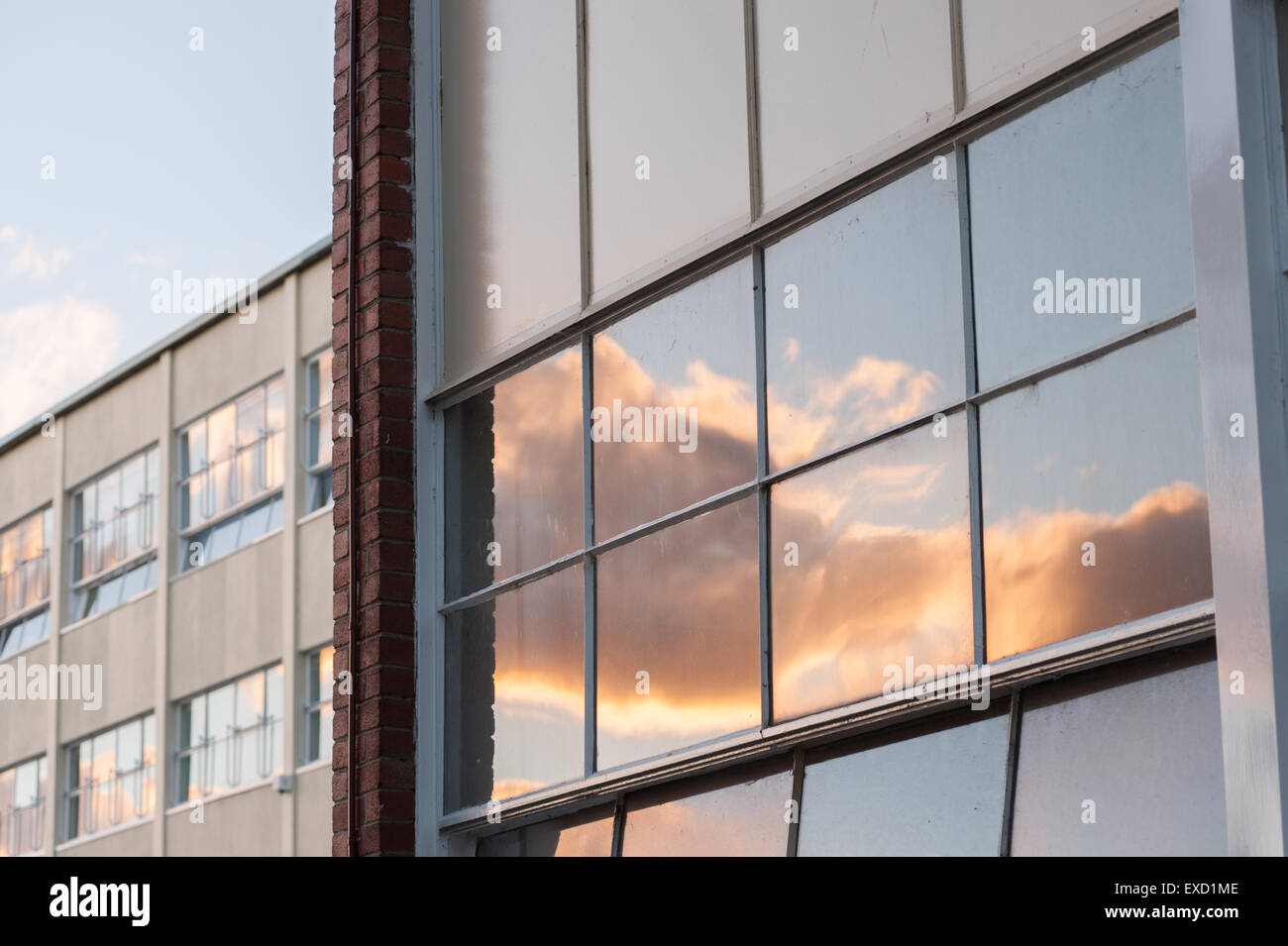 Sunset clouds reflected in a generic window Stock Photo - Alamy