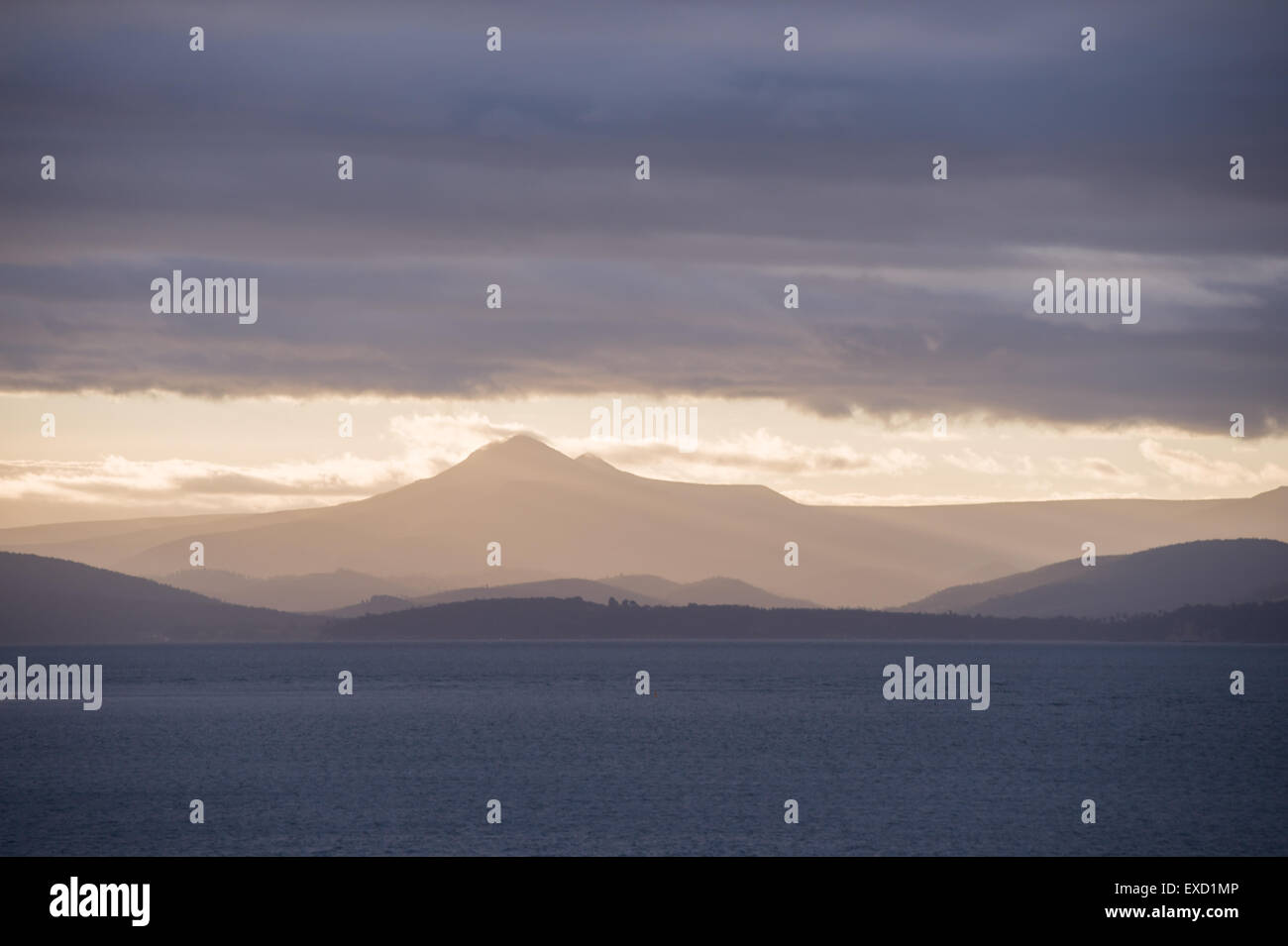 Cloud and haze mountain peak at sunset Stock Photo - Alamy
