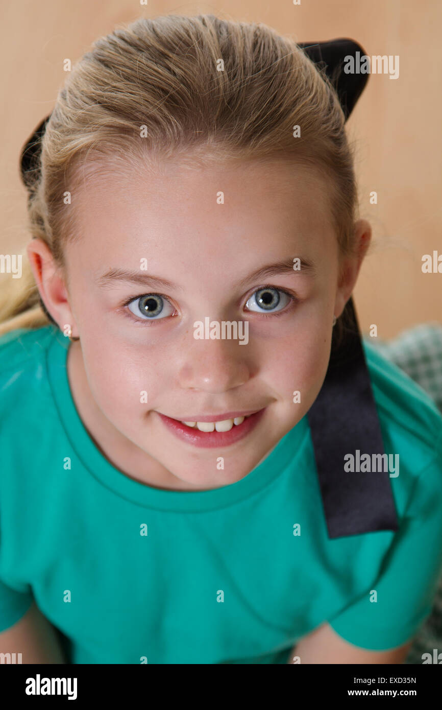 Young girl looking up at the camera smiling Stock Photo - Alamy