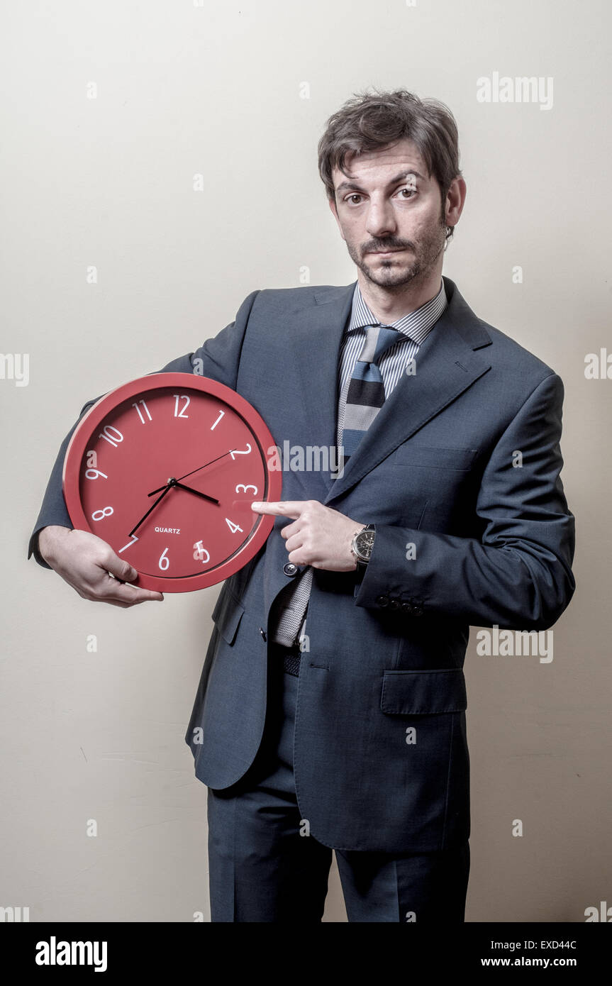 businessman pointing clock on gray background Stock Photo - Alamy