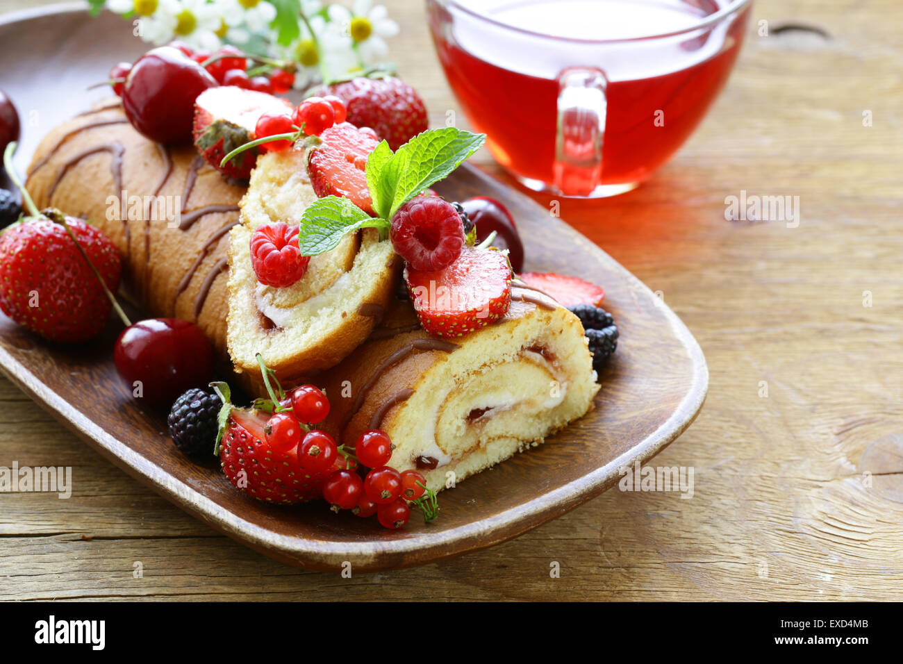 biscuit roulade with butter cream and fresh berries Stock Photo - Alamy