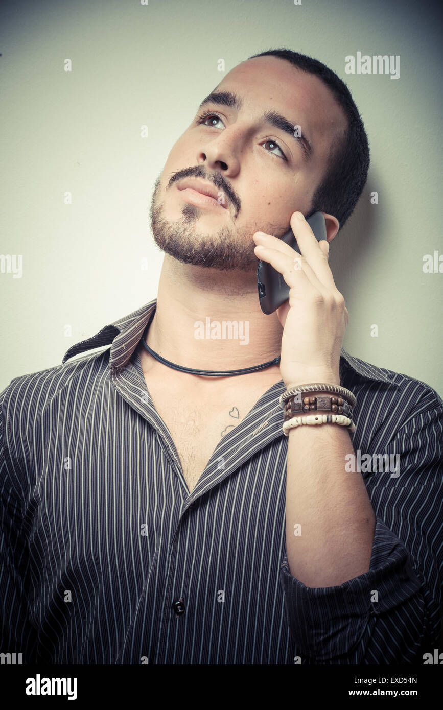 young stylish man on the phone on gray background Stock Photo - Alamy