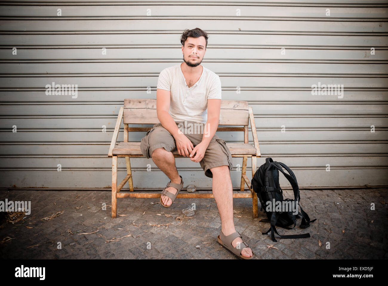 stylish man sitting on a bench in the street Stock Photo - Alamy