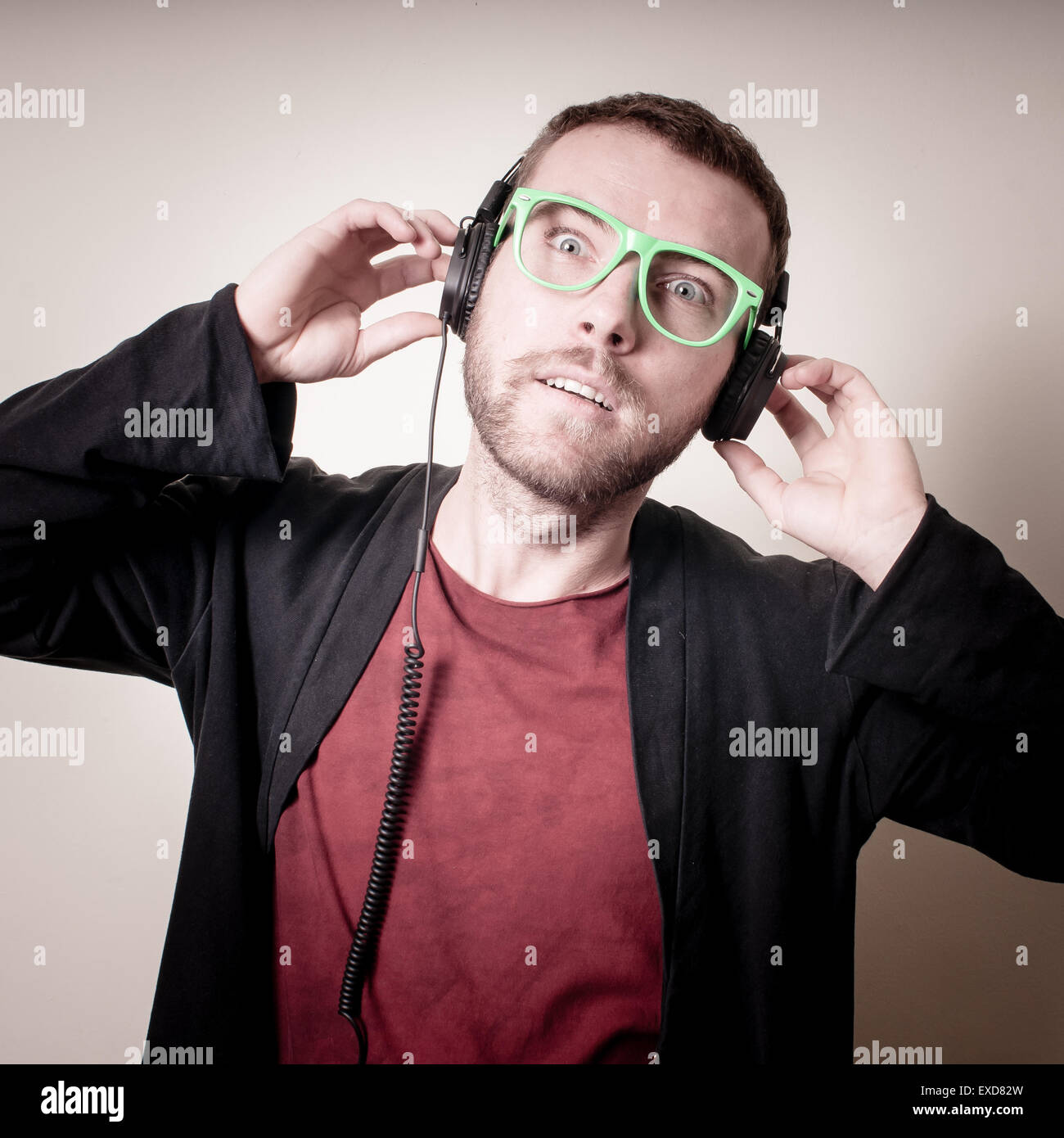 stylish hipster listening to music on gray background Stock Photo - Alamy