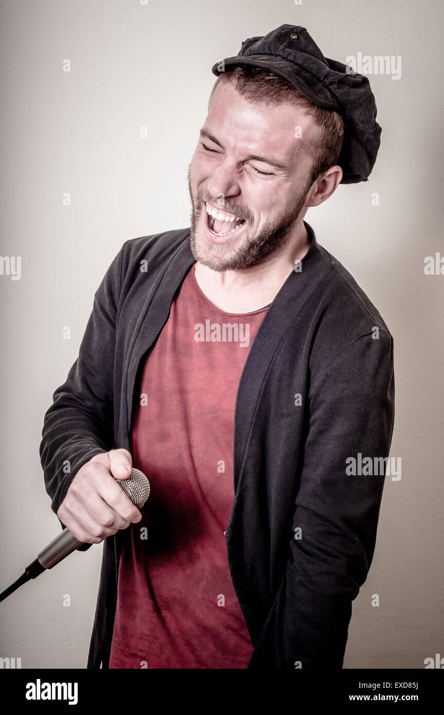 hipster stylish singer on gray background Stock Photo - Alamy