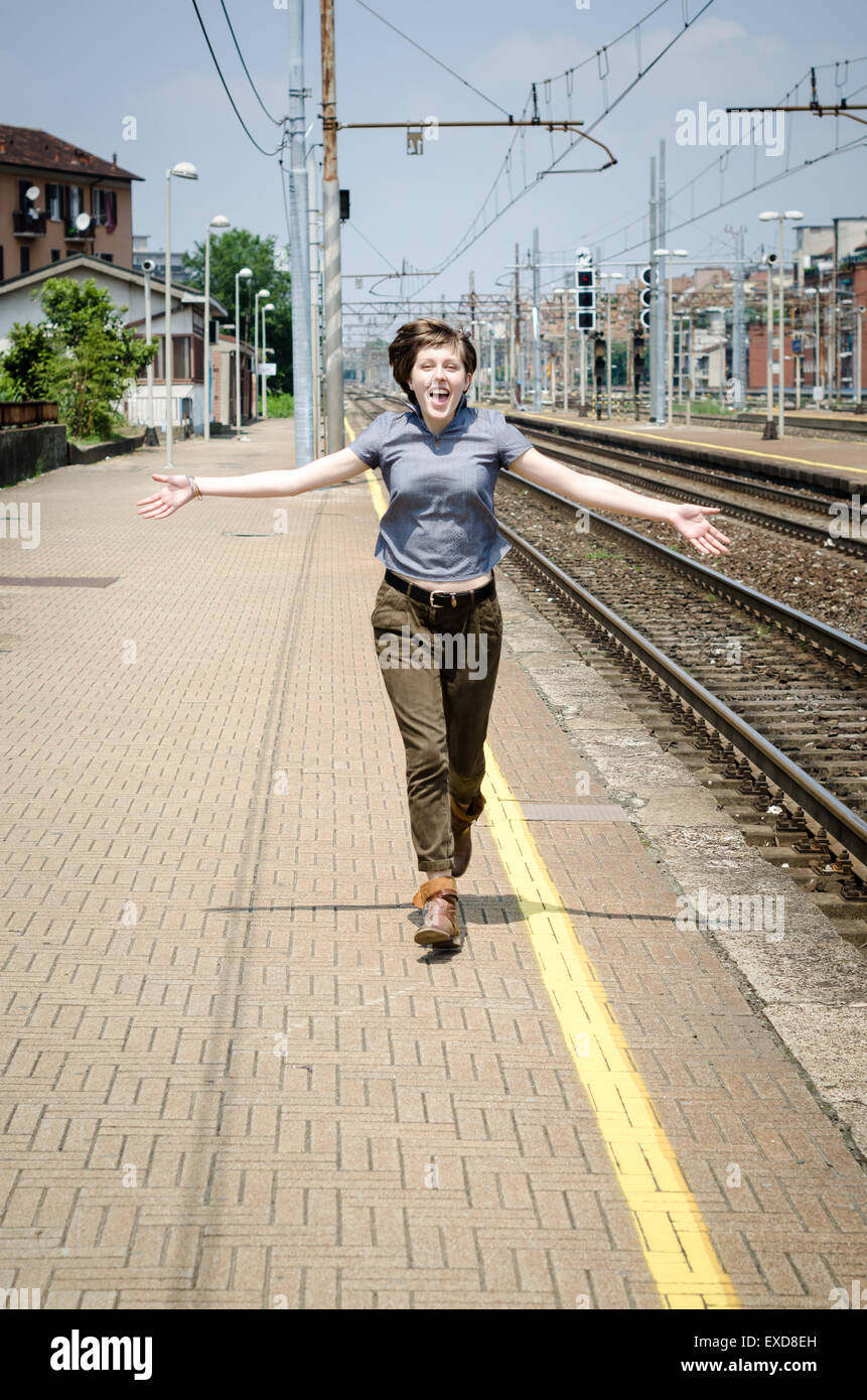 young beautiful hipster woman happy running in the station Stock Photo ...