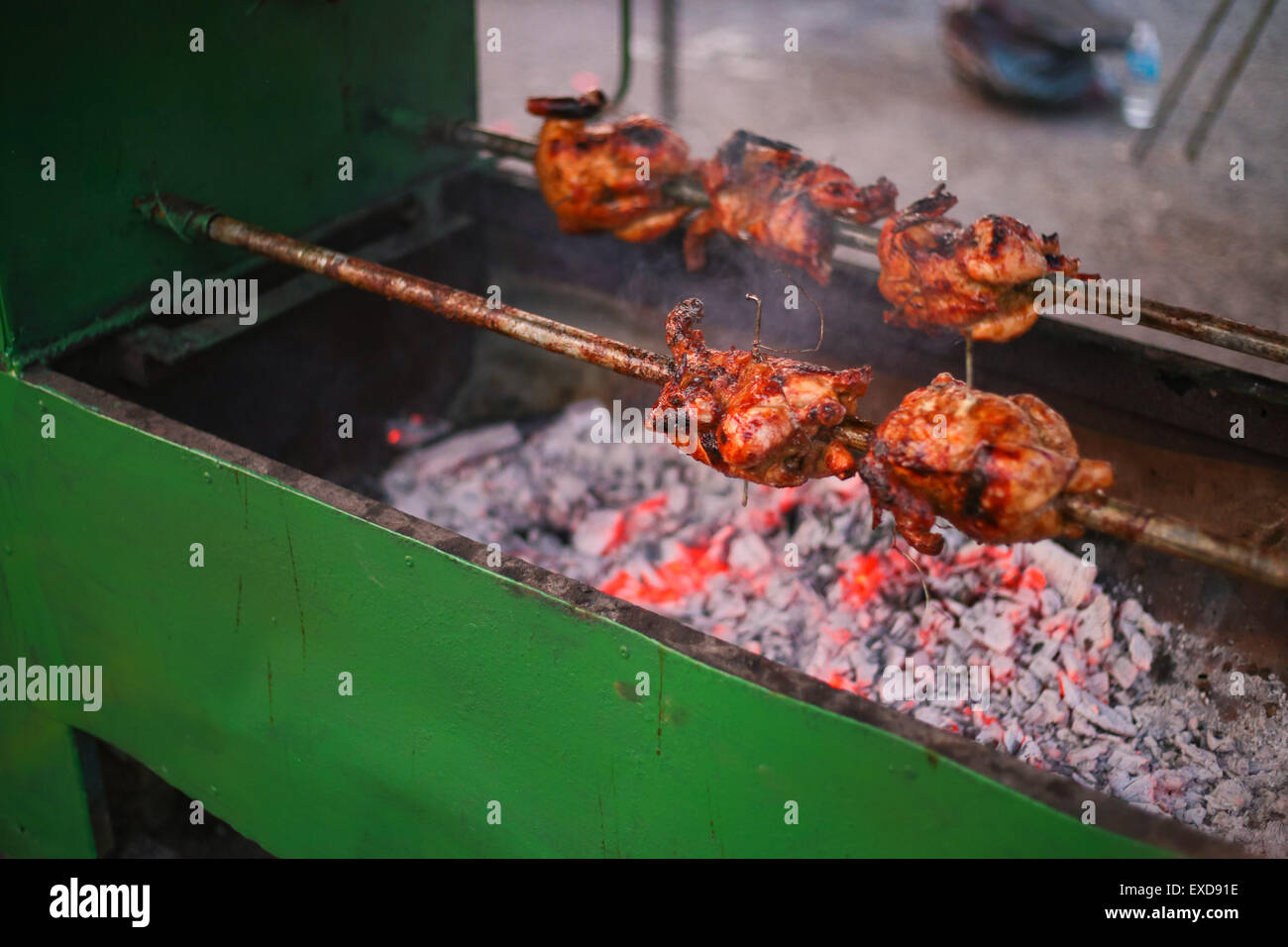 Preparation of chicken golek on a charcoal fired grill Stock Photo - Alamy