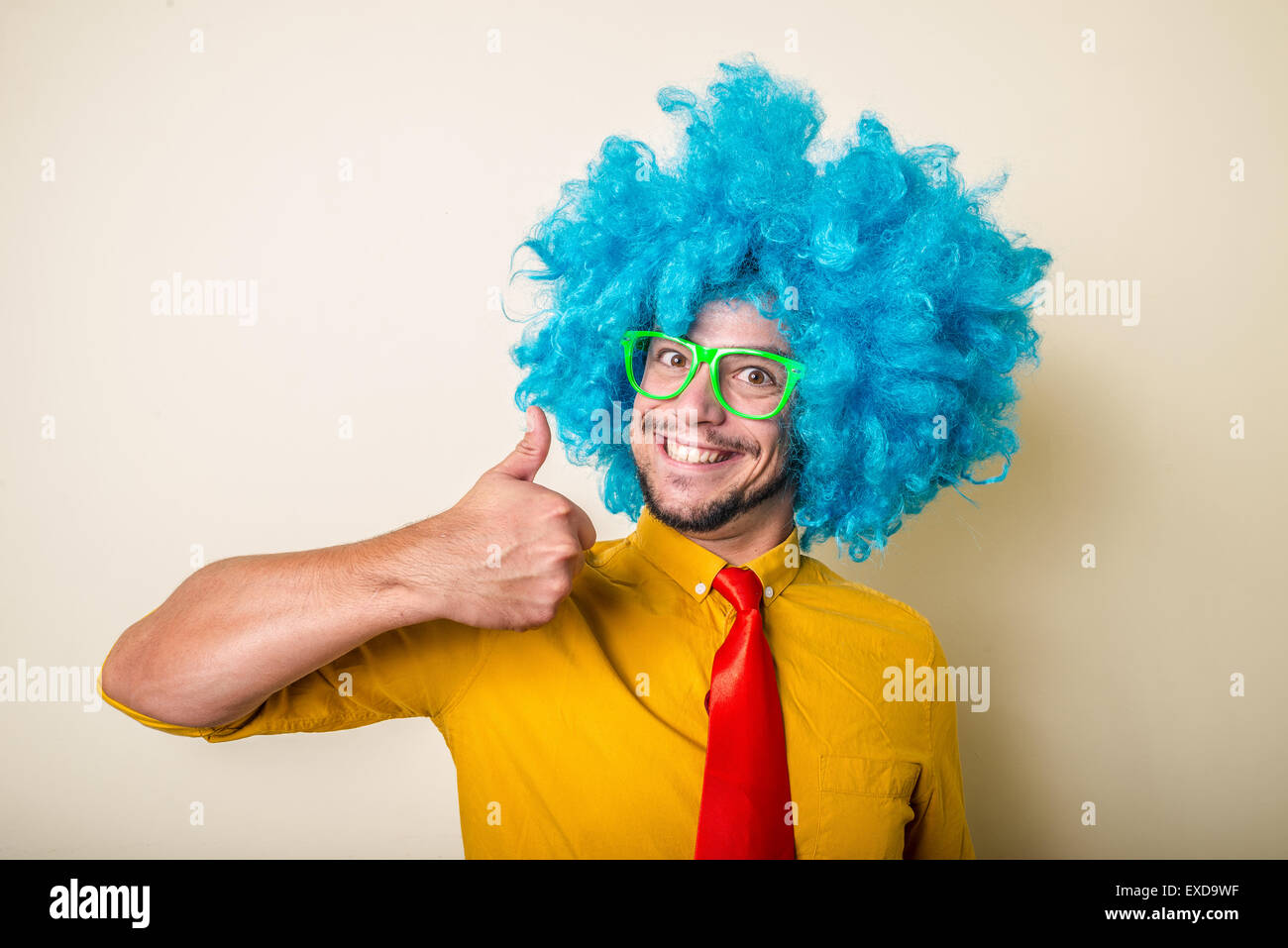 crazy funny young man with blue wig on white background Stock Photo - Alamy