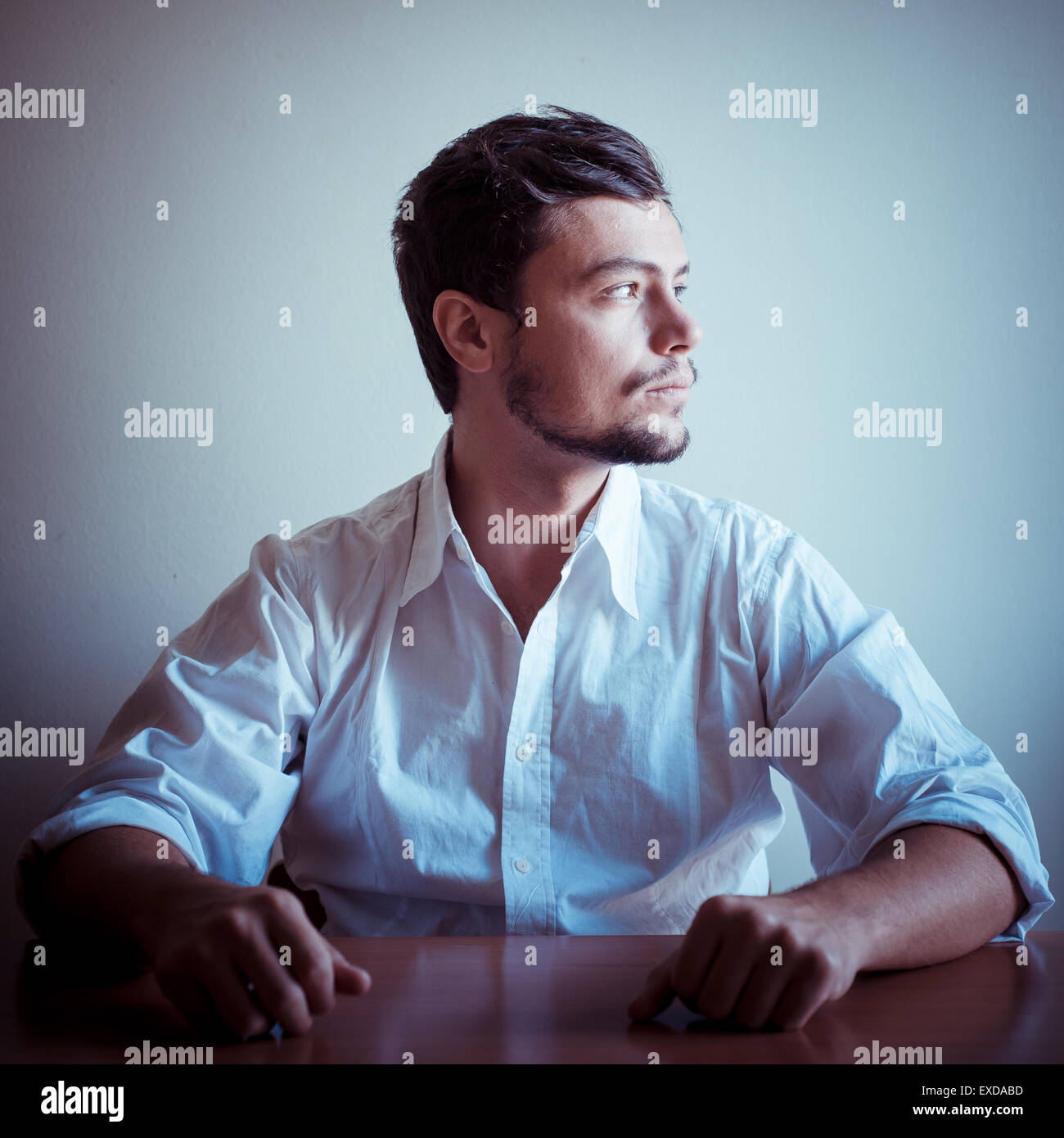 young stylish man with white shirt behind a table Stock Photo - Alamy
