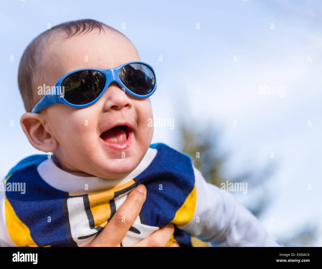 Cute 6 months old baby with Light brown hair in white, blue and ...