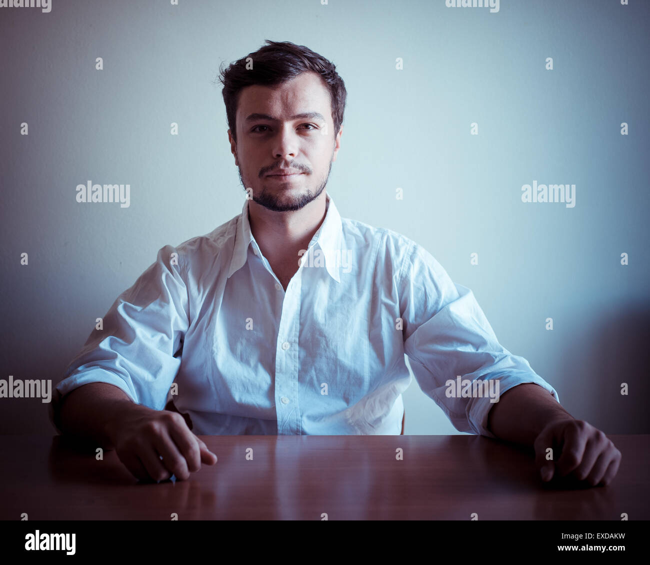 Young man behind table hi-res stock photography and images - Alamy