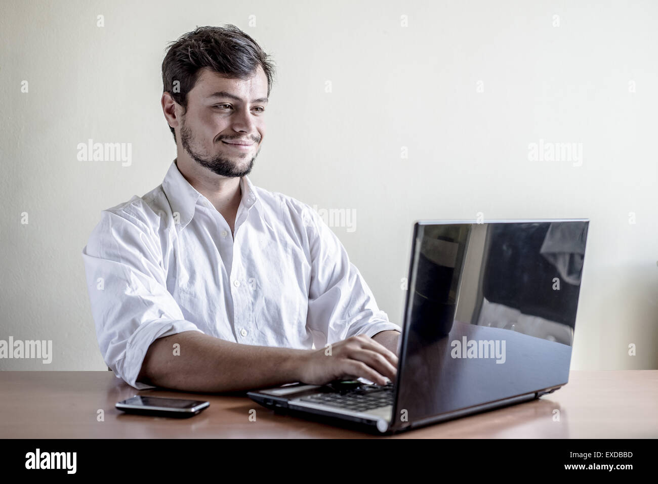 young man using notebook on the table Stock Photo - Alamy