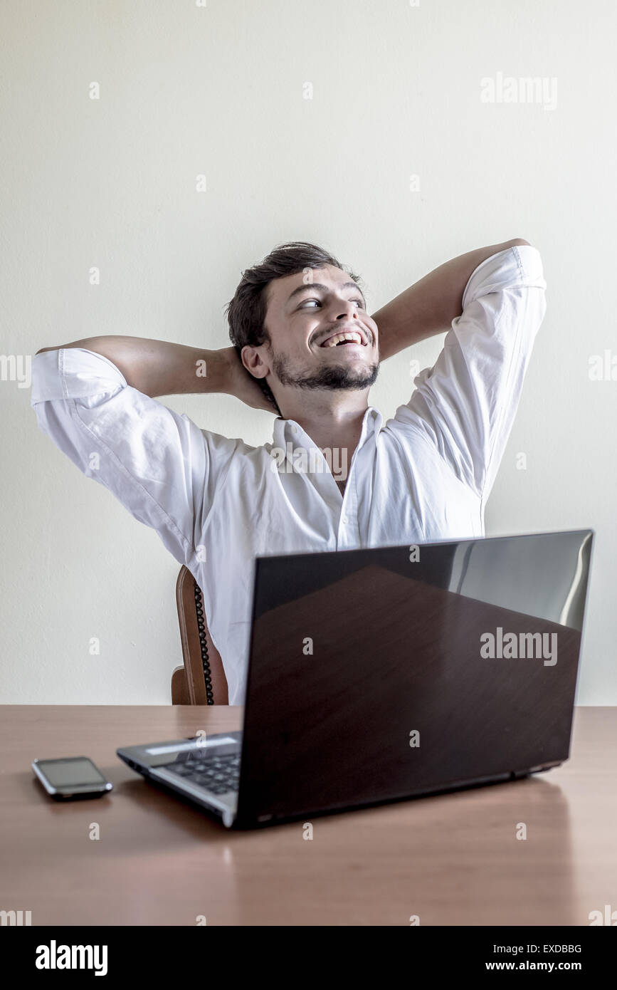 young man relaxing during work on the table Stock Photo - Alamy
