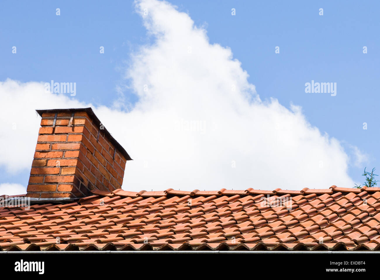A Red Chimney with Tiles and Blue Cloudy Sky Stock Photo - Alamy