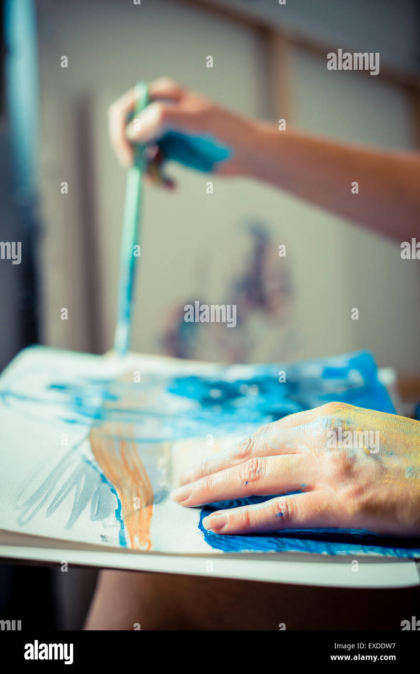 particular of woman painter hand painting in her studio Stock Photo - Alamy
