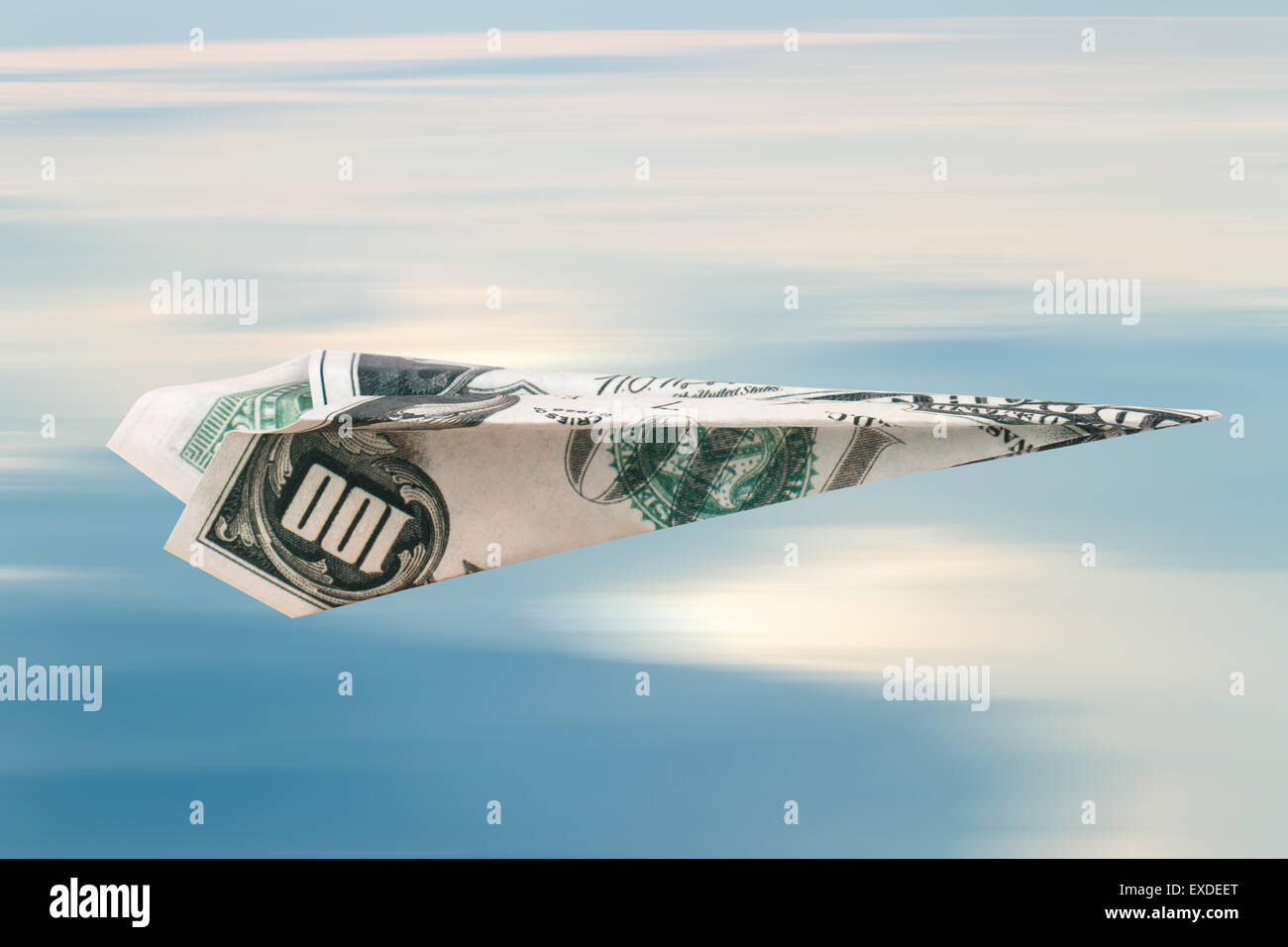 Paper plane with dollar banknote, on blue cloudy sky background Stock ...